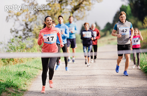 Large group of multi generation people running a race competition in ...