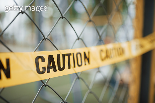 Do not enter. Yellow caution tape on the metal fence at daytime. Crime ...