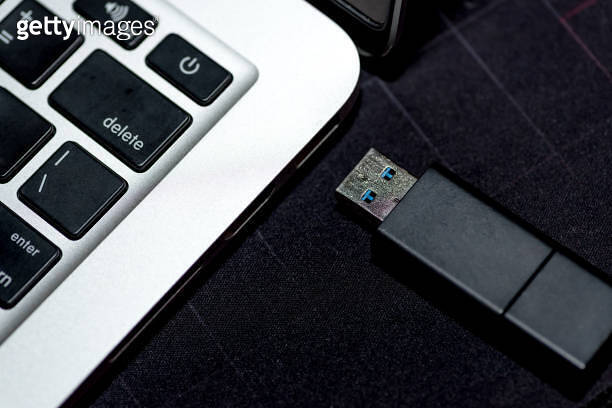 inserting USB flash memory drive plugged into a computer laptop port ...