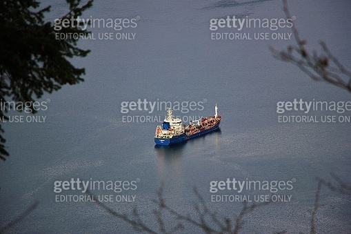 A container ship sailing on the sea in the Burrard Inlet returning to ...
