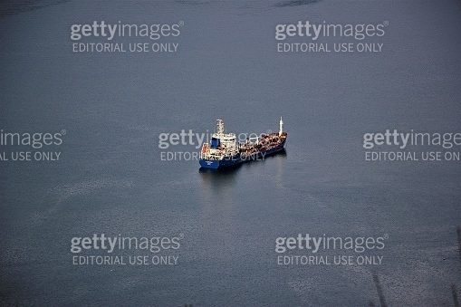 A container ship sailing on the sea in the Burrard Inlet returning to ...
