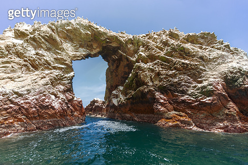 Rock formation with arch on an islet of the Ballestas Islands (Paracas ...