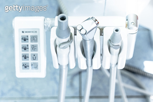 Professional dental instruments and control panel on dental chair in ...