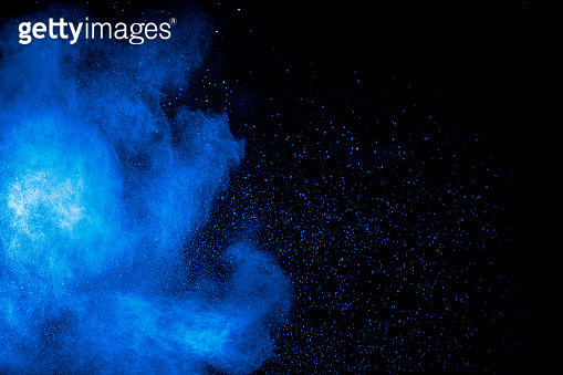 Blue powder explode cloud on black background.Launched blue dust ...