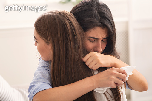 Girl Crying Hugging Her Compassionate Friend Sitting On Couch Indoor ...
