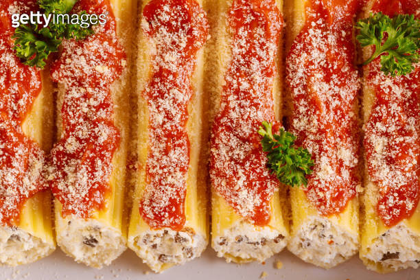 Cannelloni pasta staffed with ricotta, parmesan and mushrooms. Close up ...