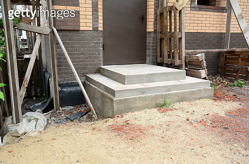 Building poured concrete front porch steps to the entrance door of a ...