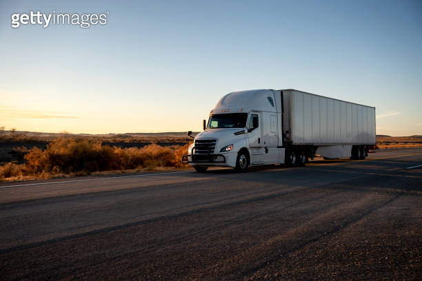 A Semi Truck Passing By On A Lonely Two-Lane Highway In Utah, Hauling A ...