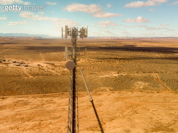 Closeup aerial view around of the telecommunications tower. On the top of a telecom tower ...
