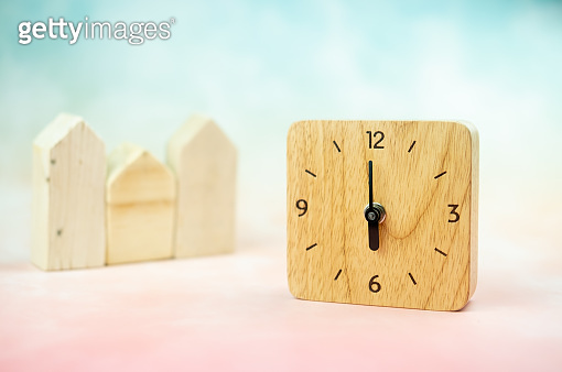 Wooden clock with blur of wooden house background. Select focus shallow ...