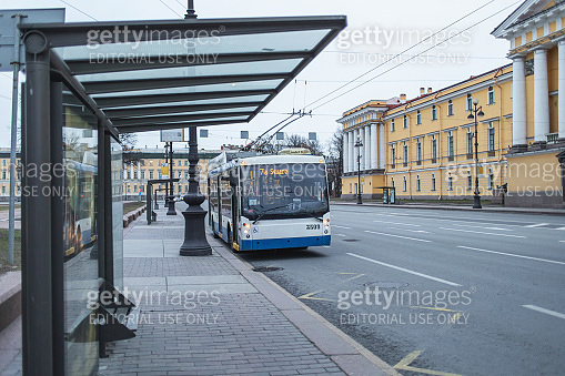 A trolleybus arrives at An empty Bus stop. Abandoned streets in the ...