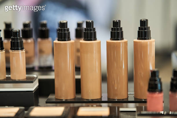 Foundation for face in glass jars of dark and light shades ...