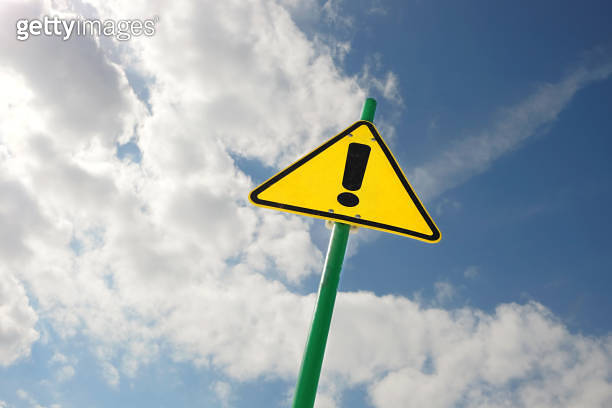 Yellow warning sign with an exclamation sign. Exclamation sign post ...