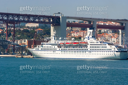 ocean liner in sea port. Ship on water under bridge on sunny day. Water ...