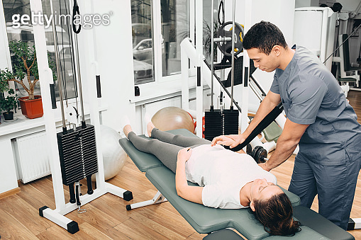 Kinesitherapy, exercises. Kinesiologist trains with the patient ...