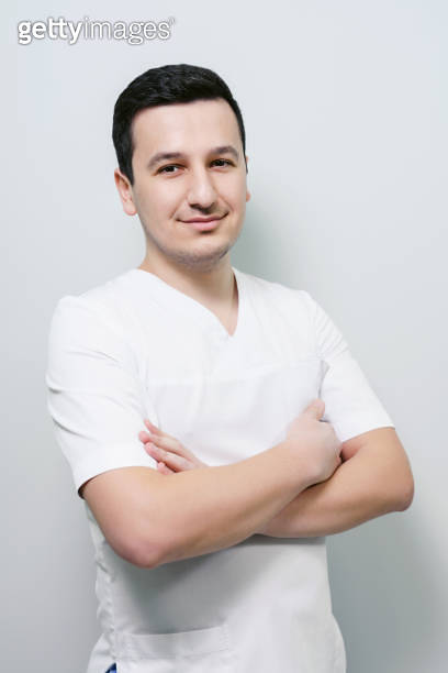 Portrait of young friendly medical doctor isolated over white ...