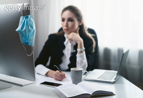 Self-isolation to prevent infection. A young woman works in a home ...