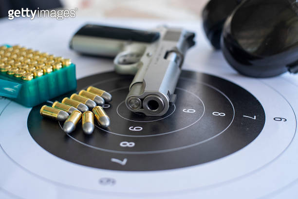 Guns with ammunition on paper target shooting practice (1197888707 ...