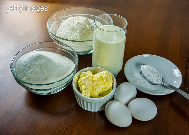 Basic ingredients for making cake, flour, sugar, milk, eggs, butter and ...