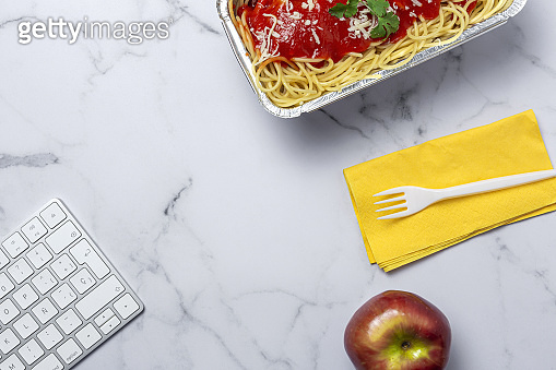 Lunch at workplace spaghetti with tomato and cheese on work table 이미지 ...