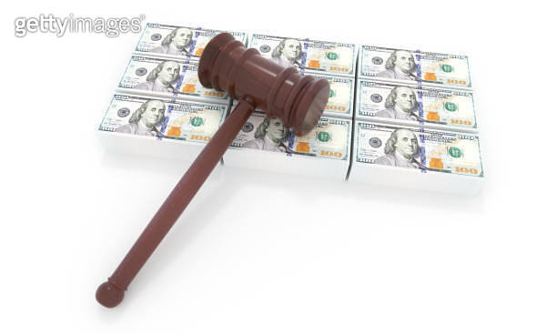 Gavel lies on a big stack of dollars. Concept of corrupt jurisdiction ...