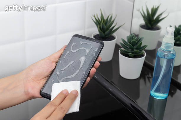 disinfect, sanitize, hygiene care. cleaning dirty stain on mobile phone ...