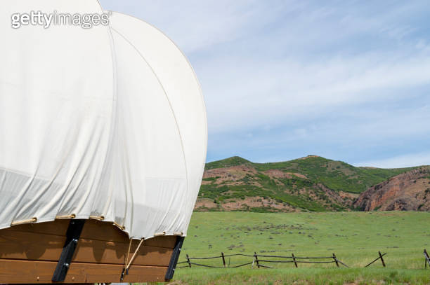 Glamping Reproduction Covered Wagon Set up Near a Grassy Field at a ...