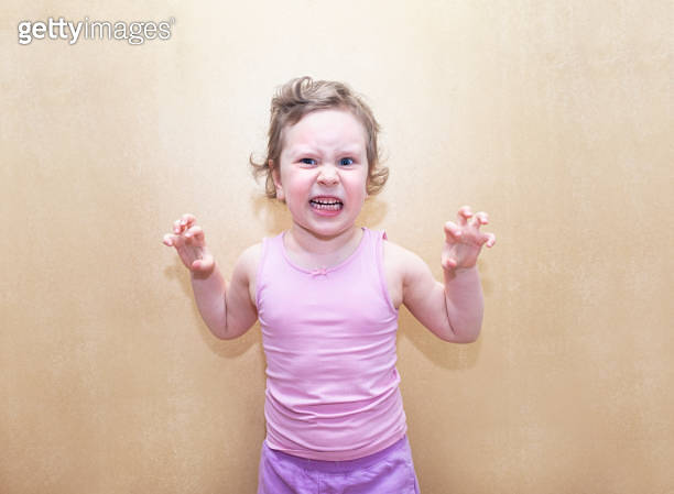 Child girl 5 years old. Emotional portrait. The child growls, imitates ...