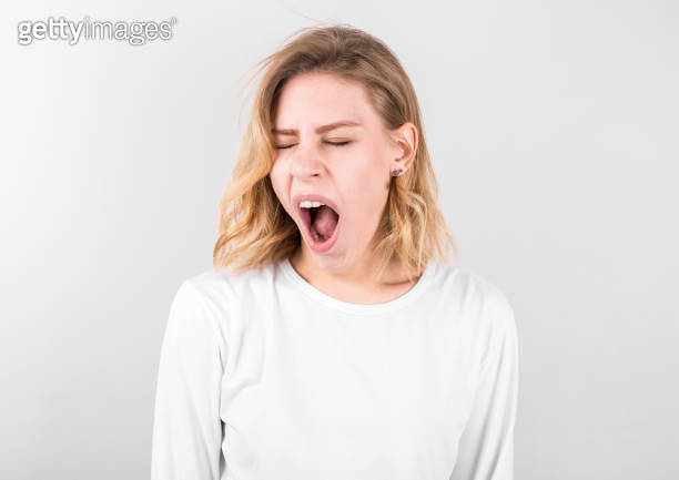 Tired woman yawning covering open mouth with hand need rest ...