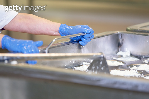 Man mixing milk in the stainless tank during the fermentation process ...
