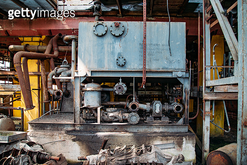 Old rusty Industrial tanks connected by pipes connected with valves in ...