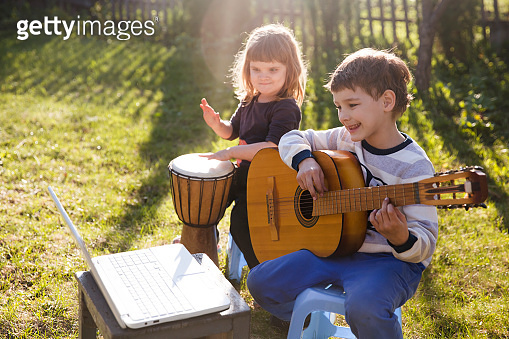 Happy kids brother and sister having fun with musical instruments ...