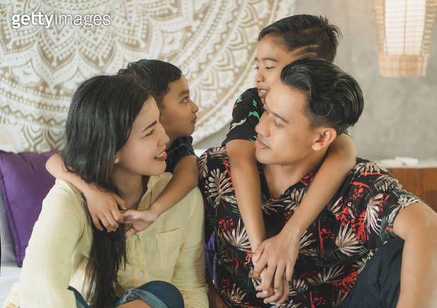 Southeast Asian family spending time at home. Happy Indonesian or ...