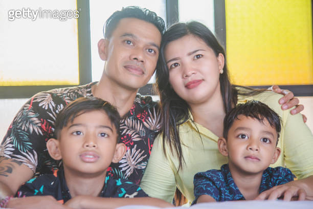 Southeast Asian family spending time at home. Happy Indonesian or ...