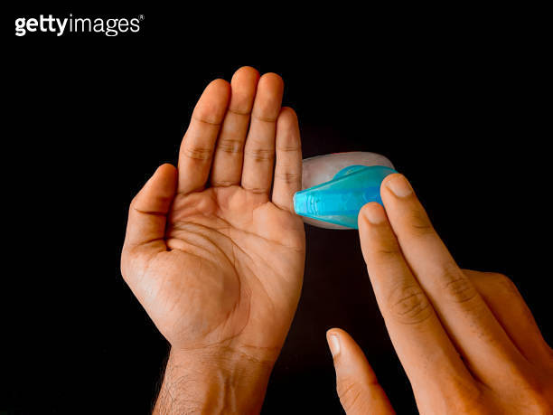 Showing using hand wash to disinfect hands as a prevention of corona ...