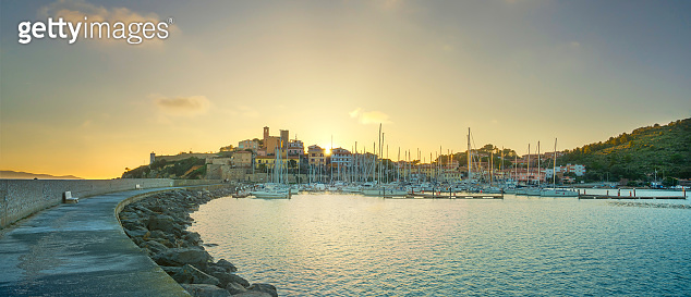 Talamone village skyline and marina at sunset. Maremma, Tuscany, Italy ...