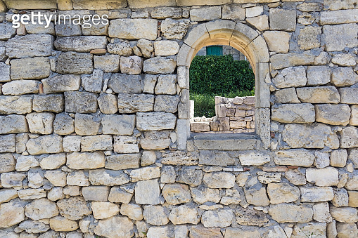 Wall with a window in the ruins of an ancient city overlooking the wall ...