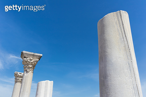 Four ancient antique Greek columns against the sky, a view from the ... Four ancient antique Greek columns against the sky, a view from the ...