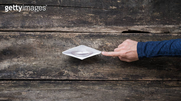 Pushing forward paper made origami boat 이미지 (1219782818) - 게티이미지뱅크