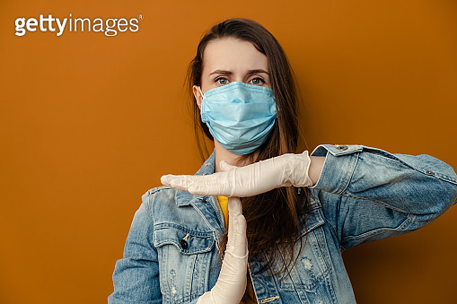 Portrait of dissatisfied woman in medical sterile face mask gloves ...