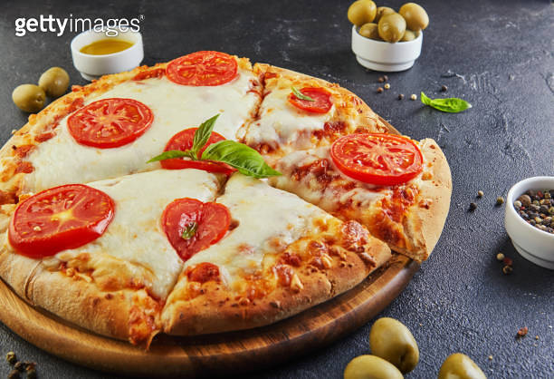 Italian pizza and ingredients for cooking on a black concrete ...