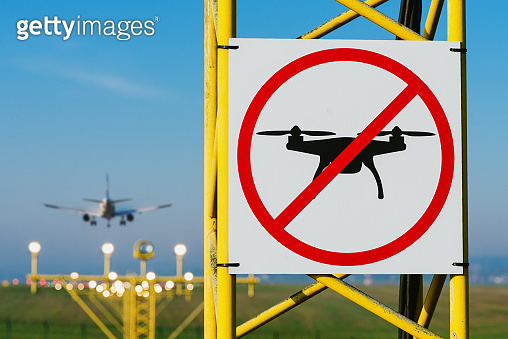 No drone zone sign on approach lighting system at runway (1198085734 ...