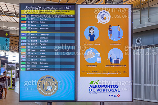 signage keep your distance and schedule of departing aircrafts at ...