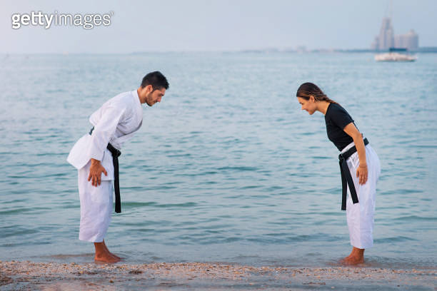 Man and woman bowing to each other as a sign of respect before and ...