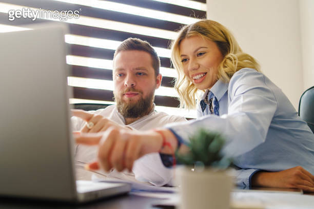 Young adult caucasian man and woman working on the laptop computer ...