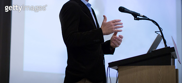 Seminar presenter at corporate conference giving speech. Speaker giving ...