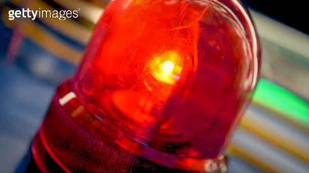Closeup image of red glowing fire alarm lights on wall at office ...