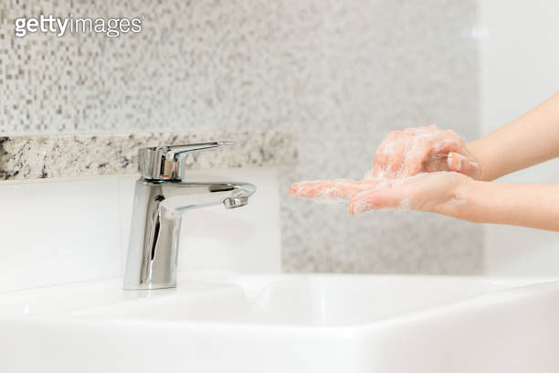 Woman use soap and washing hands on the basin. Hygiene concept ...