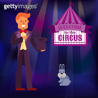 Magician in black suit performing trick with rabbit appearing from a ...