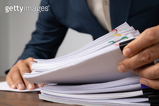 Man hand pick up Stack overload document report paper with colorful ...